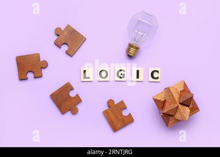 Word LOGIC with light bulb, wooden toy and puzzle pieces on lilac ...