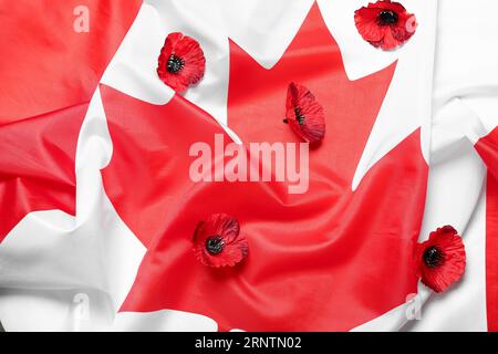Poppy flowers on flag of Canada as background. Remembrance Day Stock ...