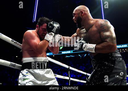 Frazer Clarke (right) strikes David Allen in the heavyweight bout at ...