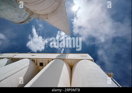 Brick chimney and concrete silos for limestone storage Stock Photo - Alamy