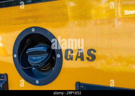 Gas cap on the side of a parked yellow school bus Stock Photo - Alamy