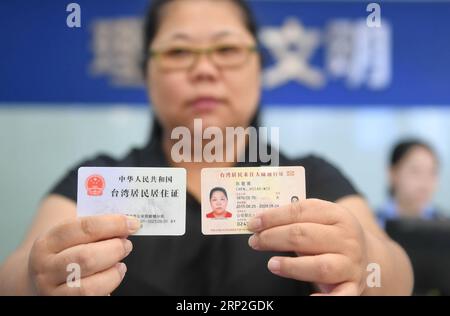 A Taiwan resident living in the Chinese mainland displays the residence ...