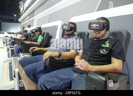 Visitors try out VR devices to ride dodgem cars at the SoReal VR ...