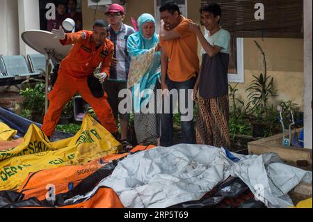 Relatives of nine victims killed in a bank robbery mourn outside the ...