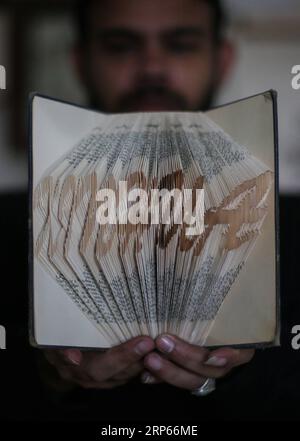 (190103) -- GAZA, Jan. 3, 2019 -- Ahmed Humaid, 28, folds paper sheets ...