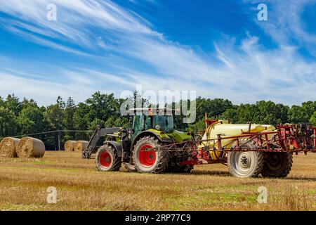 Agricultural machinery in summerfield. Rural landscape Stock Photo - Alamy