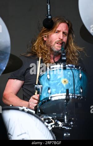 Razorlight drummer Andy Burrows performing with guitar on stage with ...