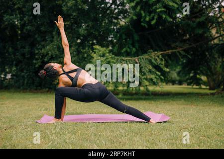 Young yogi attractive woman practicing yoga concept, doing advanced ...