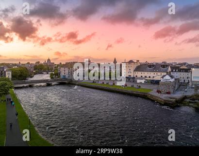 Aerial sunset panorama of Galway, harbor city on Ireland’s west coast River Corrib, Spanish Arch ...