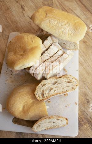 sliced bread and rolls placed on a cutting board Stock Photo - Alamy