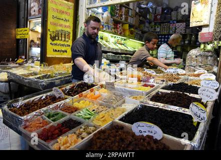DAMASCUS, Syria - People buy fruits at a fresh food market in Damascus ...