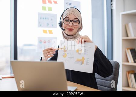 Employee decoding charts on online briefing using devices Stock Photo ...