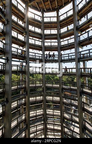 visitors walking inside the 40-meter-high observation tower, part of ...