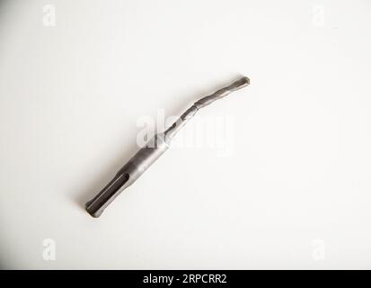 Poor quality broken metal drill on a white background Stock Photo - Alamy