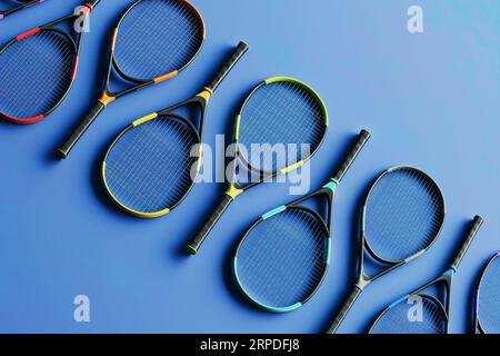 Professional tennis racquets in various colors. Blue background. Game ...