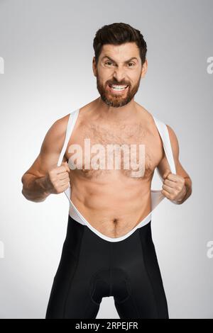 Aggressive caucasian wrestler in black and white singlet, while posing ...