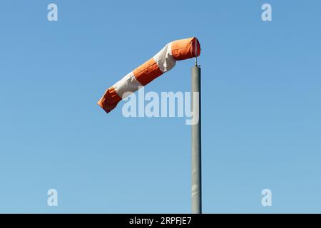 A red and white wind cone indicating the direction and strength of the ...