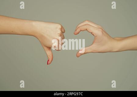 Dislike. Female and male hands in form of heart and dislike. Hands in ...