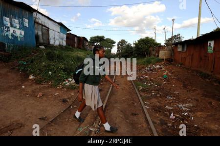 KENYA, Nairobi, Kibera slum, railway line, commuter train in the ...