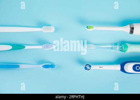 Electric toothbrushes on light blue background, flat lay Stock Photo ...