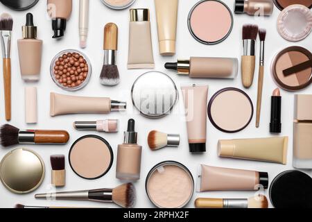 Face powders and other makeup products on white background, flat lay ...