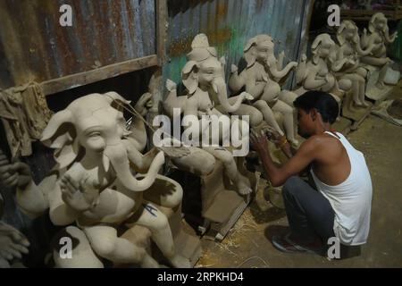 An Idol maker making idols of Lord Ganesh in a studio for the upcoming ...