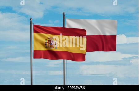 Spain and Poland flag waving together in the wind on blue sky, two ...
