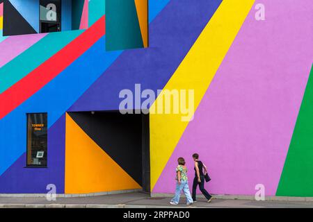people walk past the Towner Art Gallery with colourful Dance Diagonal artwork by German artist ...