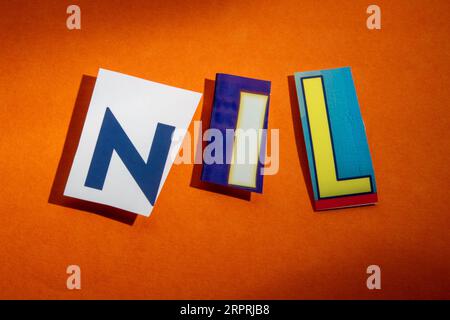 The acronym "NIL" (Name, image, likeness) using cut-out paper letters ...