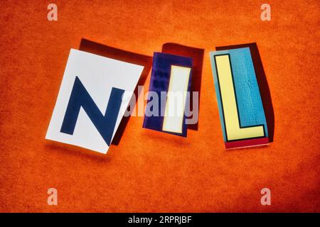 The acronym "NIL" (Name, image, likeness) using cut-out paper letters ...