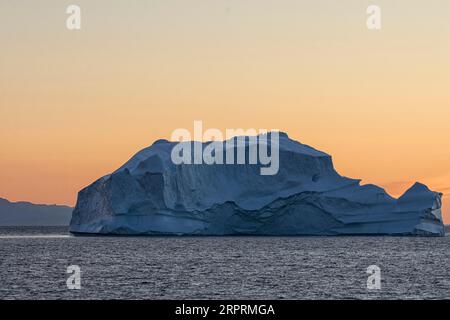 Impressive floating iceberg in Disko Bay in the arctic early morning ...