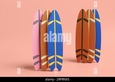 Different mini surfboards on pink background Stock Photo - Alamy