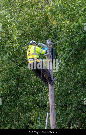 a workman working at height wearing an high visibility vest without any ...