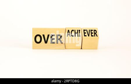 Achiever or overachiever symbol. Businessman turns wooden cubes and ...