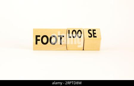 Foot or footloose symbol. Businessman turns wooden cubes and changes ...