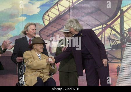 Harry Combs, aviation pioneer, seated in wheelchair, with First Flight ...