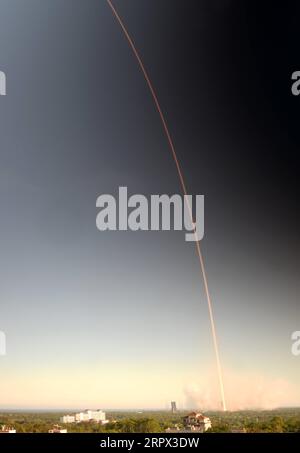 In this photo made with a slow shutter speed, light rain falls outside ...