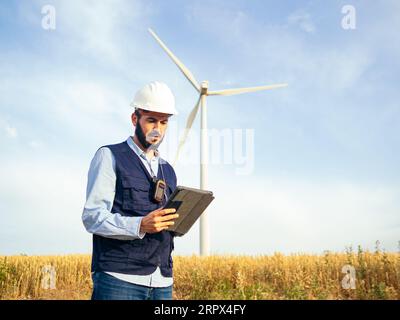 Engineer working on tablet and laptop in site construction Stock Photo ...