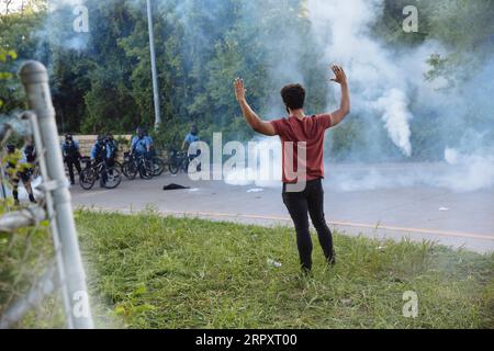 Minneapolis Police officers fire tear gas at protesters in Minneapolis ...
