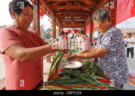 Villagers participate in a zongzi-making competition at a senior ...