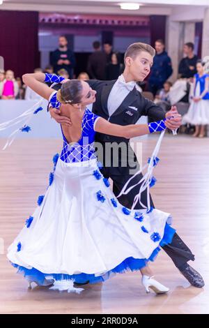 High school graduates dancing waltz and classical ball dance in dresses ...