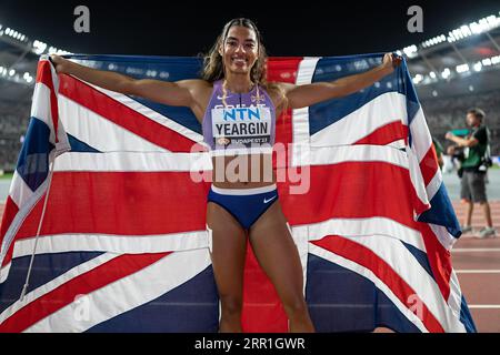 Nicole Yeargin celebrating her medal with her country's flag in the ...