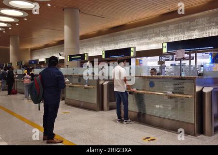 Passengers pass through passport control counters in Tribhuvan ...
