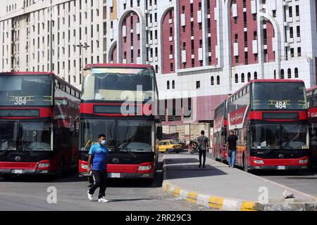 201006 -- BAGHDAD, Oct. 6, 2020 -- Red double-decker buses are seen in ...