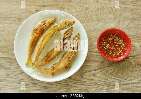 crispy fried sand whiting fish arranging on plate dipping spicy chili ...