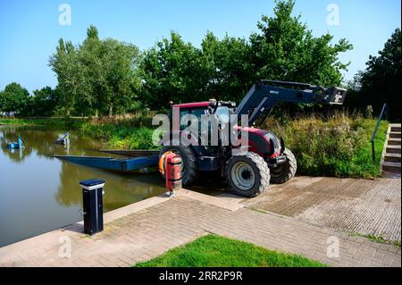 A tractor and specialist trailer are being used to haul a narrowboat ...