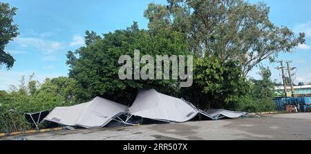 The aftermath of a typhoon, with broken buildings and debris scattered ...