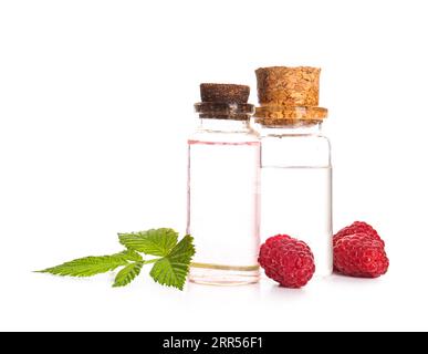 Bottles of cosmetic raspberry oil on white background Stock Photo - Alamy