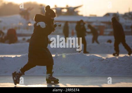 210103 -- HARBIN, Jan. 3, 2021 -- People skate on ice near Jiuzhan Park ...
