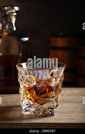 Glass of cold whiskey with wooden barrels on dark background Stock ...
